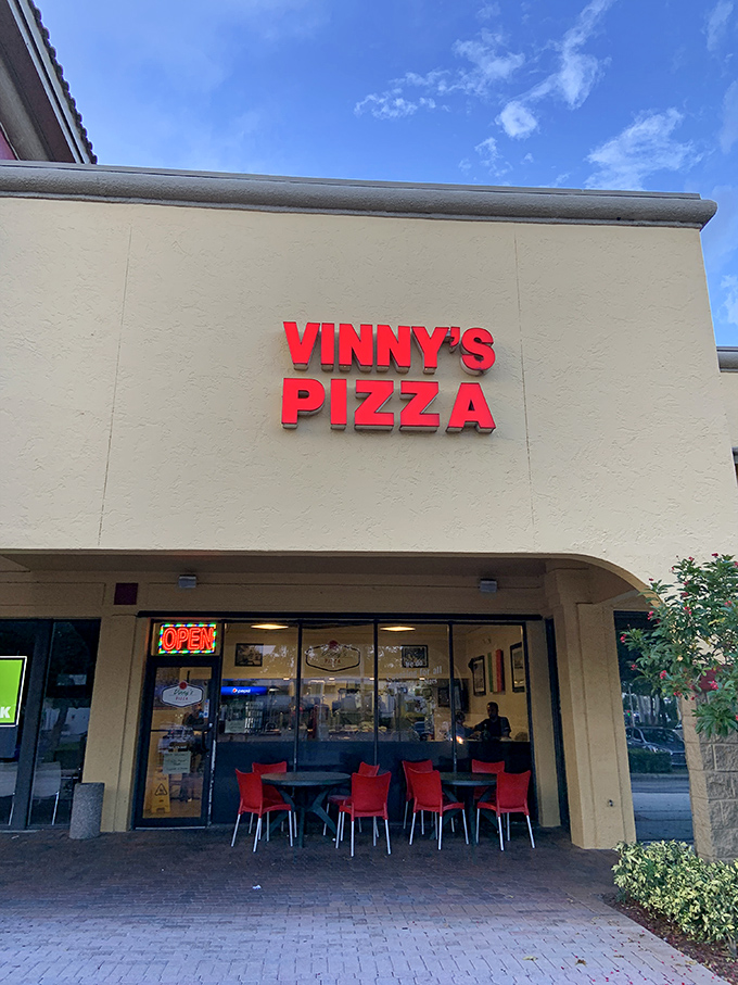 Vinny's keeping it real! This no-frills exterior hides a treasure trove of pizza perfection. Talk about a slice of heaven!