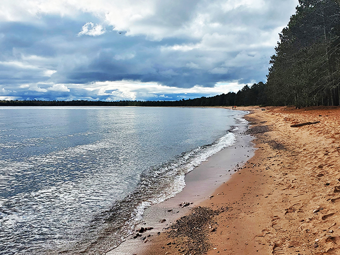 Brownstone cliffs play hide-and-seek with the shoreline. It's like Mother Nature's own game of Peek-a-Boo, but with better views!