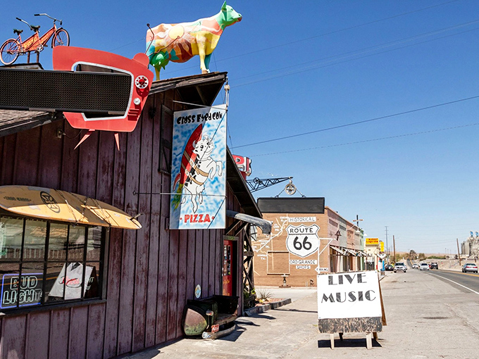 Is that a cow on the roof? You bet your boots it is! Inside, the pizzas are as colorful as the decor.