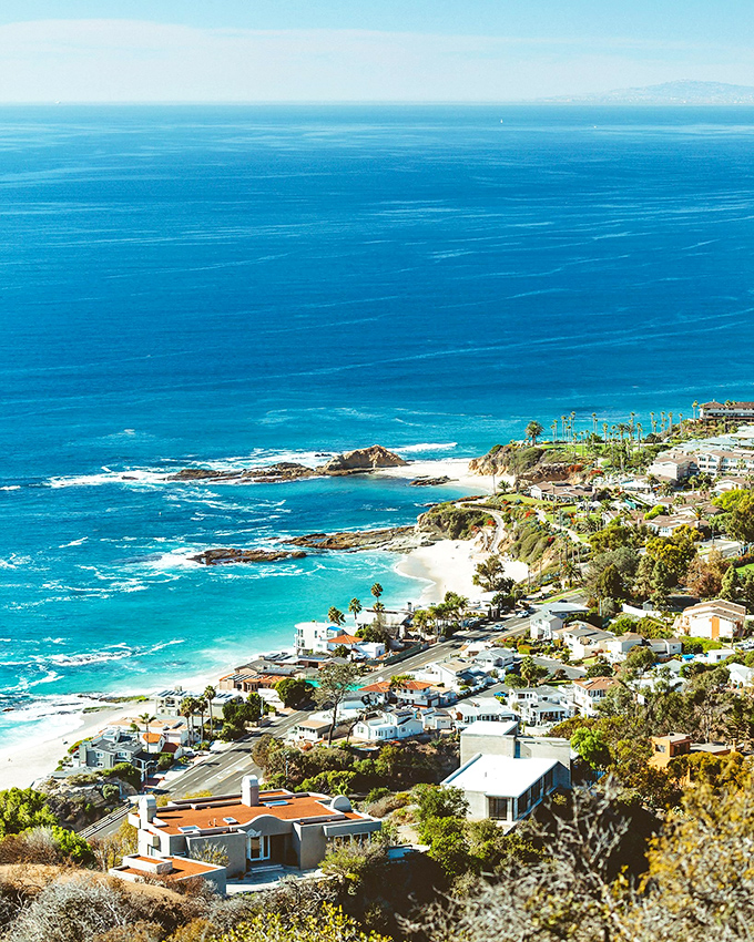 Surf's up in Laguna! Crystal-clear waters and gentle waves invite beachgoers to dive in and embrace their inner beach bum.
