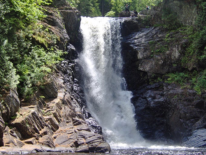 Talk about a refreshing sight! Moxie Falls cascades down like nature's ultimate thirst-quencher, surrounded by a forest straight out of a Bob Ross painting.