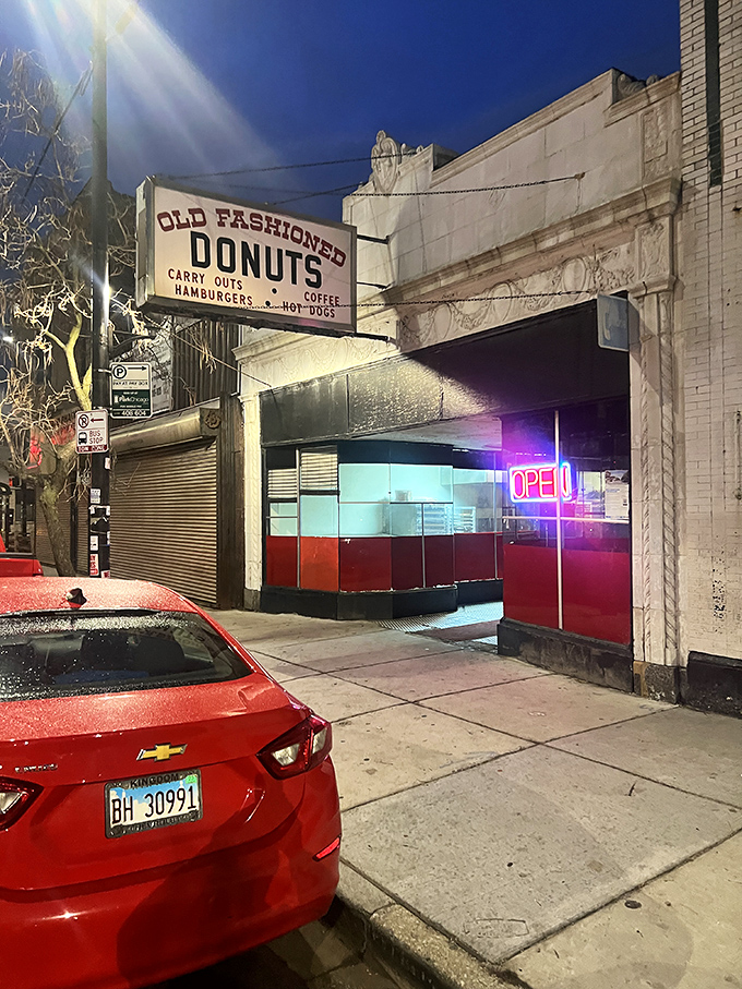 By day, it's an unassuming shop. By night, it's a neon-lit beacon of hope for sugar-seekers. Old Fashioned Donuts: always open, always delicious.