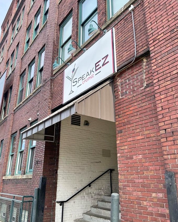 Same building, different era! SpeakEZ's sign beckons you to leave 2023 at the door and embrace your inner flapper or dapper dan.