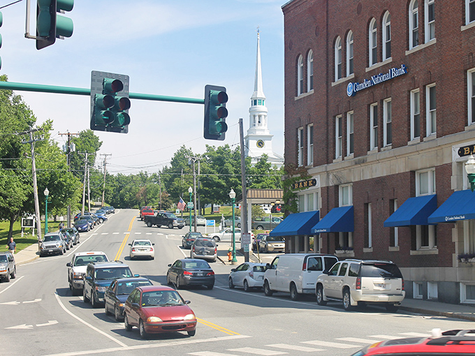 Banking on charm! Camden National's stately presence anchors Main Street, while the church steeple plays peek-a-boo in the background.