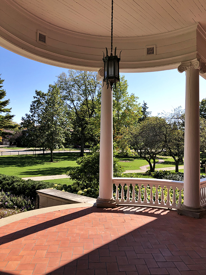 Columns, curves, and charm, oh my! This porch is begging for a rocking chair and a tall glass of lemonade.