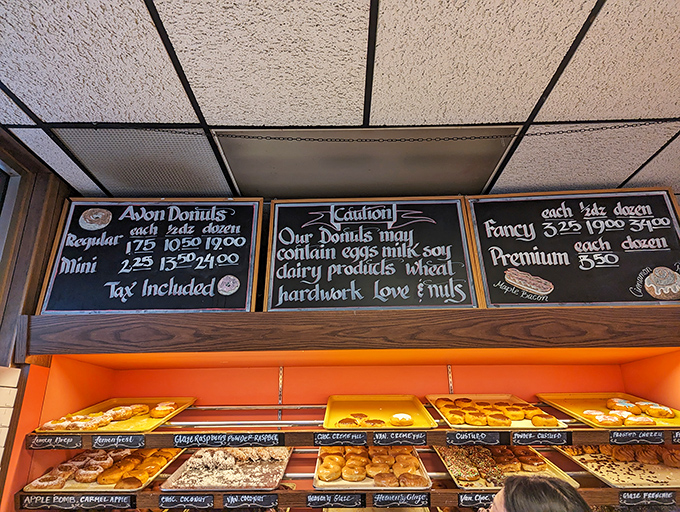 Behold, the chalkboard of dreams! A menu that reads like a love letter to fried dough, with a side of cheeky charm.