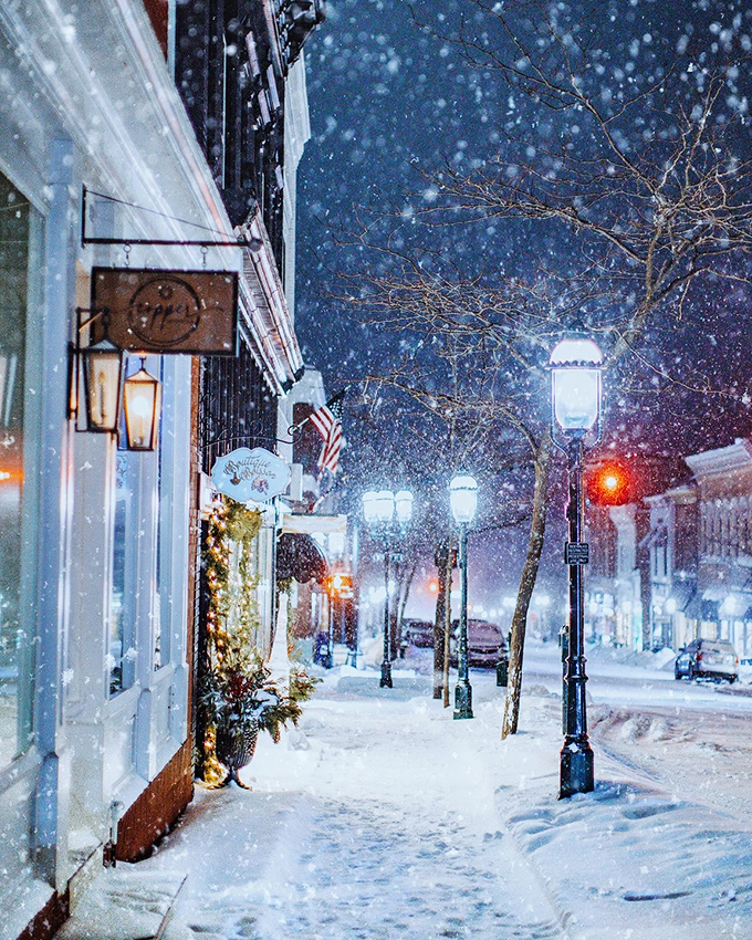 Winter wonderland on Main Street: Snowflakes dance under vintage streetlamps, transforming Petoskey into a scene straight out of "It's a Wonderful Life." George Bailey would feel right at home here.