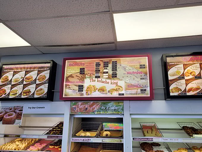 The menu board: a roadmap to flavor town. From classic glazed to wild creations, it's a choose-your-own-adventure of doughy delight.