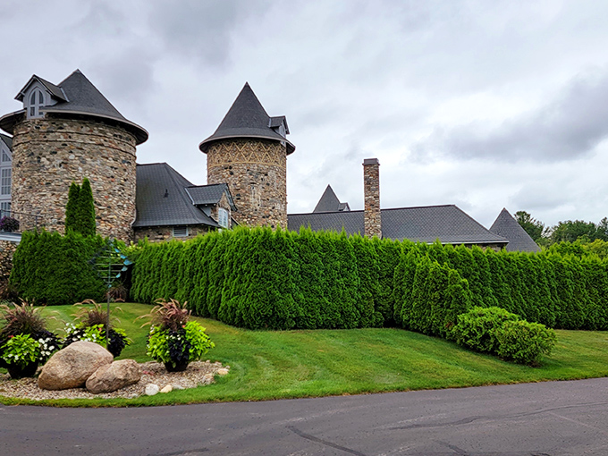 Hedges so perfectly trimmed, Edward Scissorhands would be jealous. The castle's stone walls peek out, hinting at the wonders within.