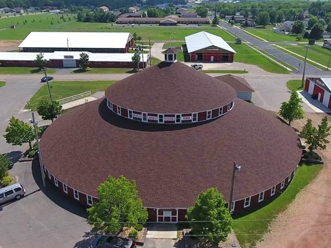 From above, it's a bull's-eye of agricultural ingenuity. This aerial view showcases the barn's perfect symmetry &ndash; no corners for sneaky cows to hide!