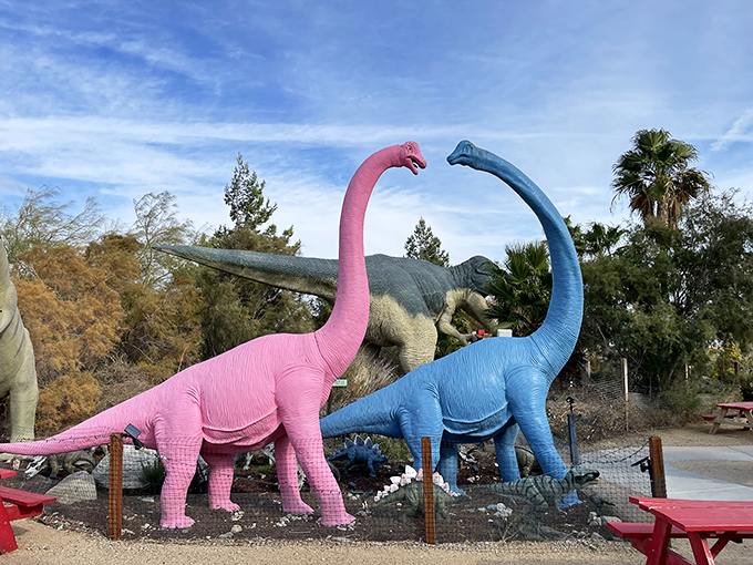 It's a dino dance party! Pink and blue long-necks groove while a T-Rex photobombs in the background.