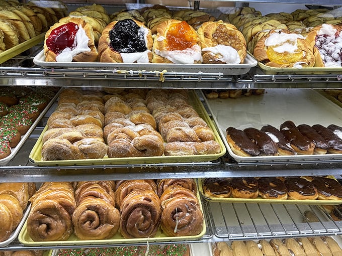 Behold, the wall of temptation! This display case is like a museum of edible art, each piece more enticing than the last.