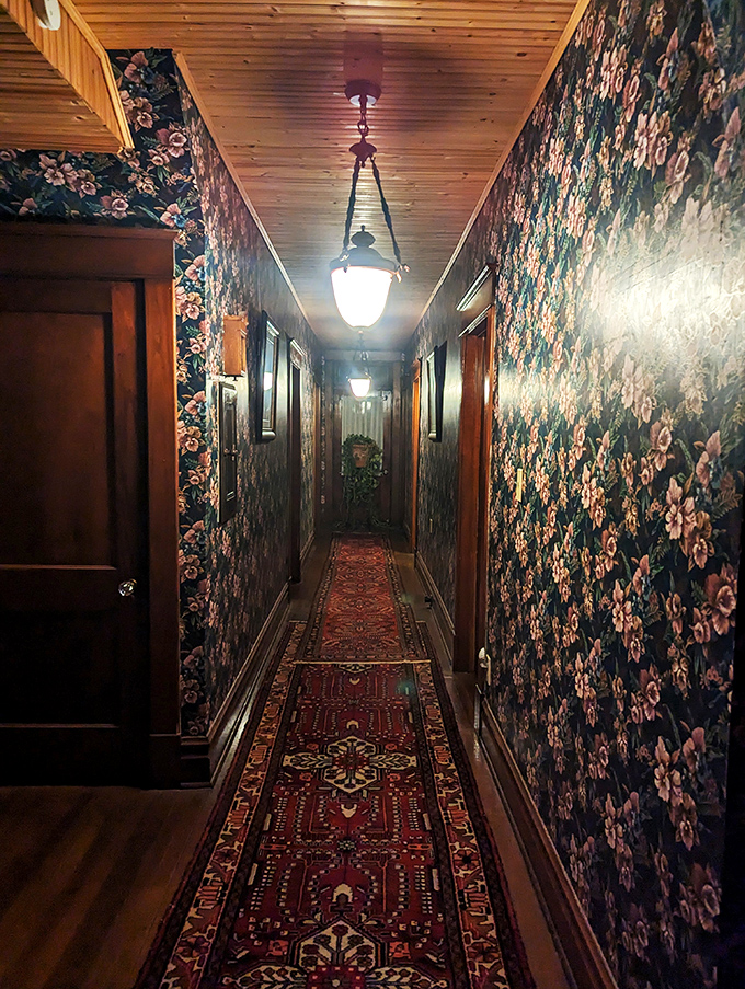 Step into a floral time warp! This hallway's wallpaper is so vibrant, you'll wonder if you've stumbled into Monet's garden or grandma's favorite tea parlor.