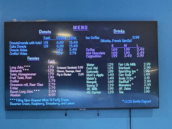 Behold, the sacred text of sweetness! This menu board is like a treasure map, guiding hungry explorers to their sugary destinies. X marks the spot... for donuts!