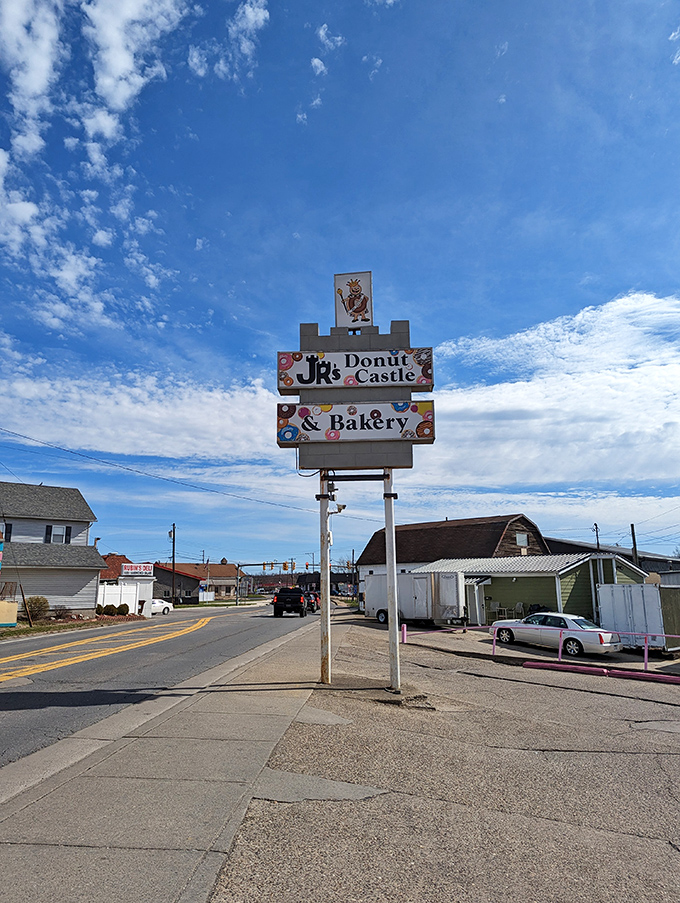 The beacon of breakfast bliss! JR's sign stands tall, a sugary North Star guiding hungry travelers to donut paradise.