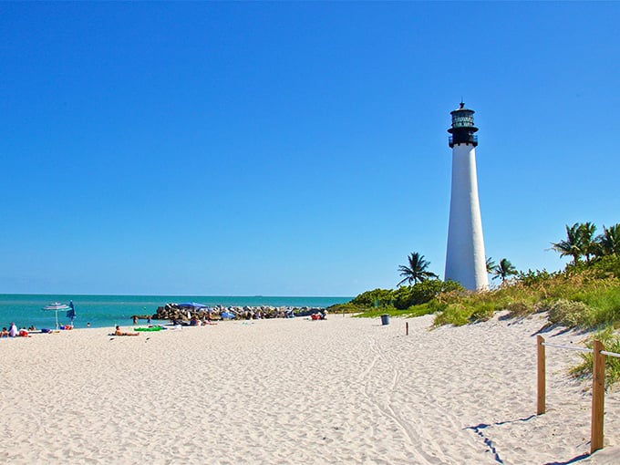 Sun, sand, and a slice of history: Cape Florida Lighthouse stands proud, a white beacon against the turquoise sea.