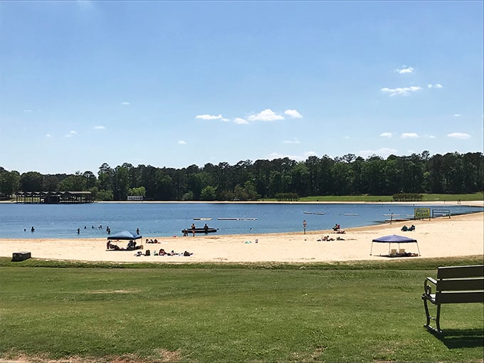 Umbrellas dot the shore like a flock of technicolor birds. Robin Lake Beach: proving you don't need an ocean to have a five-star beach day.