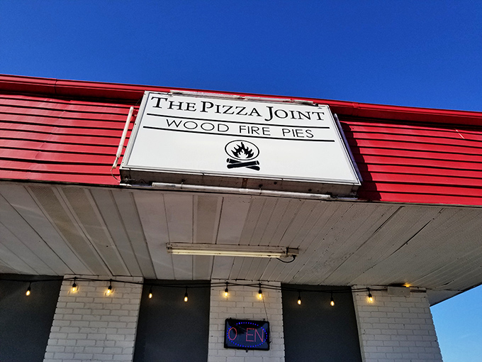 Flames and flavor unite! This humble exterior conceals a world of wood-fired wonders. Don't judge a pizza by its cover!