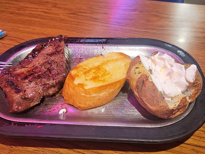 A plate that screams "Montana!" Juicy steak, fluffy baked potato, and enough sour cream to make a dairy cow blush.