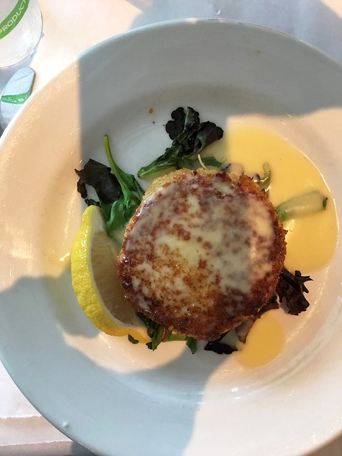 Golden-brown perfection on a plate! This crab cake is so packed with succulent meat, it might just do the cha-cha right off your fork.