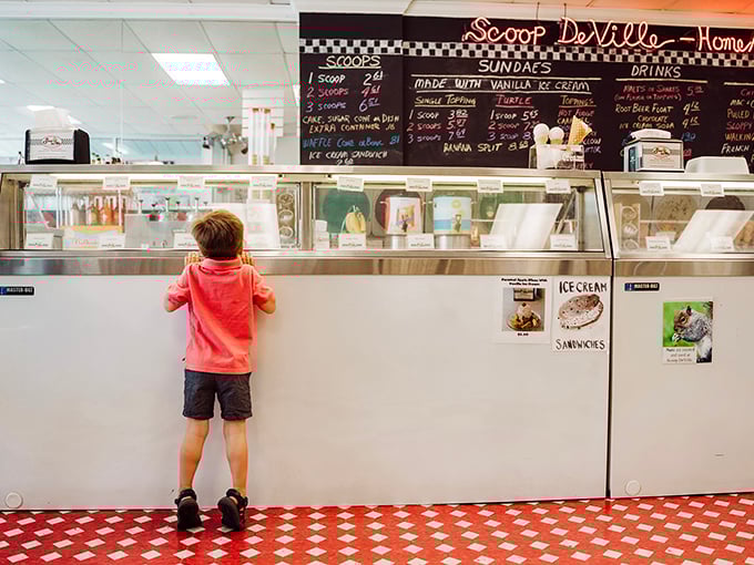 Ice cream dreams in the making. This little guy's tiptoe stance perfectly captures the anticipation we all feel at the counter.