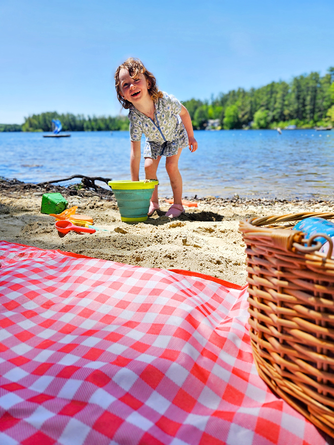 Sand castles and giggles galore! This little beach bum is living her best life, equipped with the ultimate picnic spread.