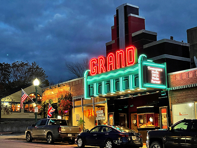 Lights, camera, nostalgia! The Grand's neon sign blazes against the twilight, promising silver screen dreams and buttery popcorn memories.