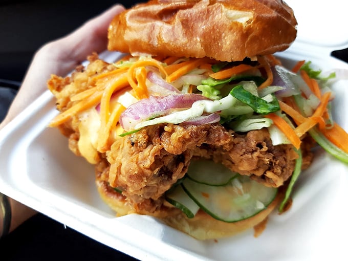 Sandwich goals achieved! This chicken creation is stacked higher than a Jenga tower, with flavors that'll make your taste buds do a happy dance.
