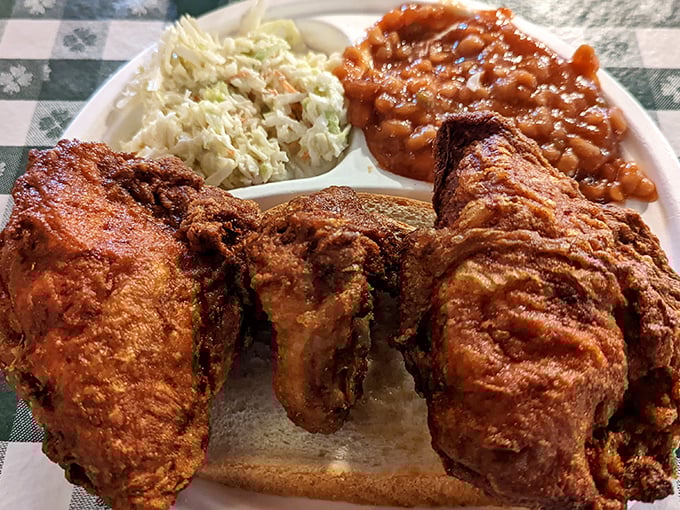 The holy trinity of Southern comfort: crispy chicken, creamy slaw, and beans that could make a vegetarian question their life choices. It's a plate that whispers, "Nap time is coming."