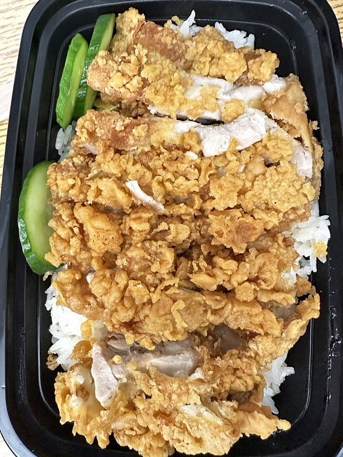 Golden crispy goodness atop a bed of fluffy rice. This isn't just fried chicken; it's a crunchy, juicy masterpiece that'll make your taste buds sing.