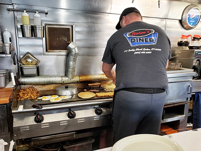 Where the magic happens! Norm's kitchen crew works their breakfast alchemy, turning simple ingredients into gold-standard comfort food.