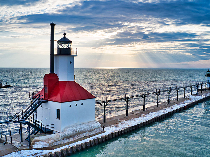 Ahoy, lighthouse lovers! This red-capped beauty stands guard over Lake Michigan like a maritime traffic cop with impeccable style.