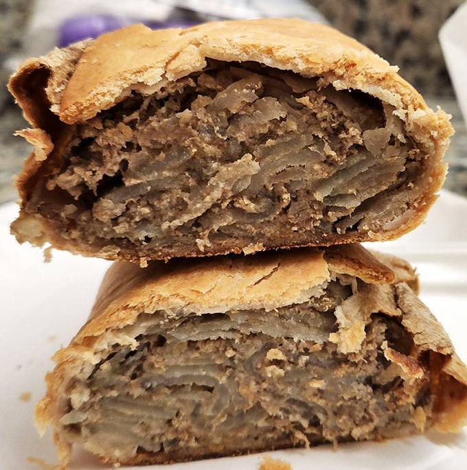 Behold, the Picasso of pasties! This cross-section reveals a masterpiece of savory beef and veggies cradled in flaky perfection.