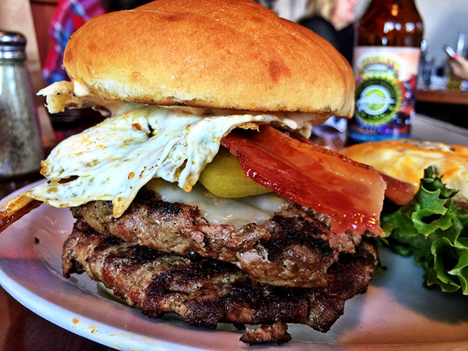 Holy cow! This burger's stacked higher than my unread emails. It's a towering testament to the art of burger-building.