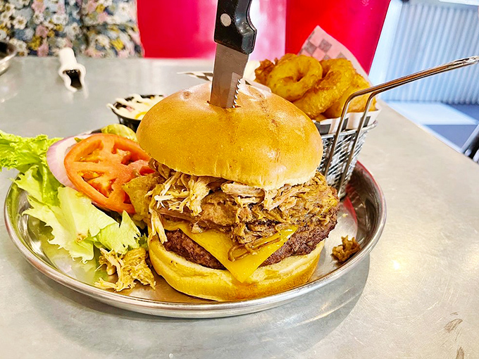 Holy cow! This burger's stacked higher than my grandpa's stories about walking to school uphill both ways. It's a towering tribute to American excess.