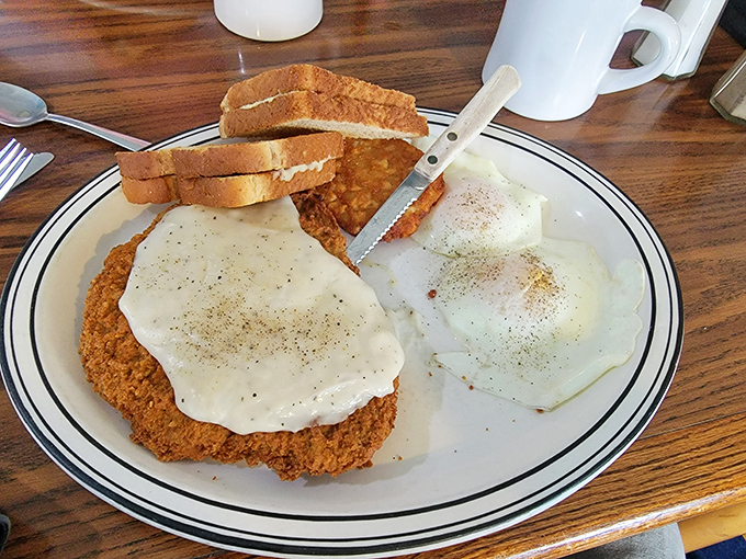 Holy schnitzel! This chicken fried steak is so big, it's got its own area code. Crispy, creamy, and comforting &ndash; it's a hug on a plate.