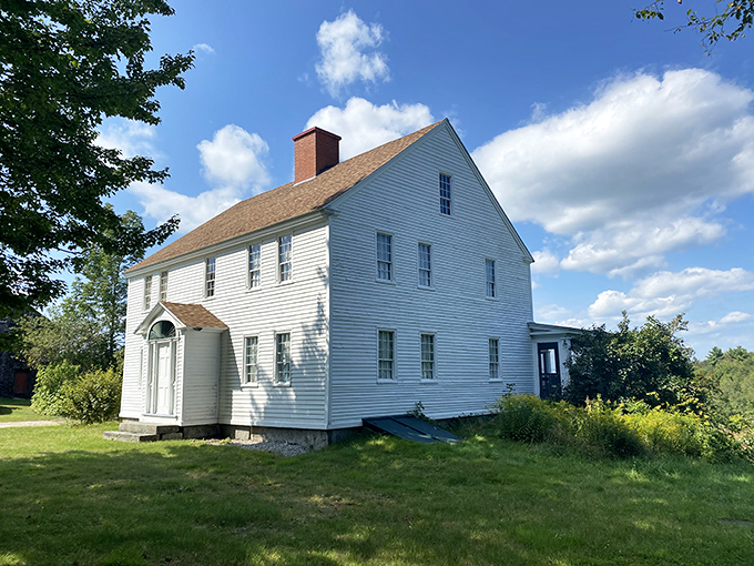 Narramissic Farm: where history and nature do a beautiful dance. This pristine white farmhouse stands proudly against a backdrop of Maine's lush greenery, whispering tales of yesteryear.