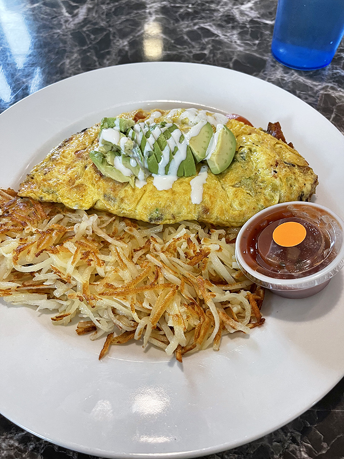 Behold, the Avocado Bacon Omelet in all its glory! It's like a breakfast burrito decided to ditch the tortilla and go commando.