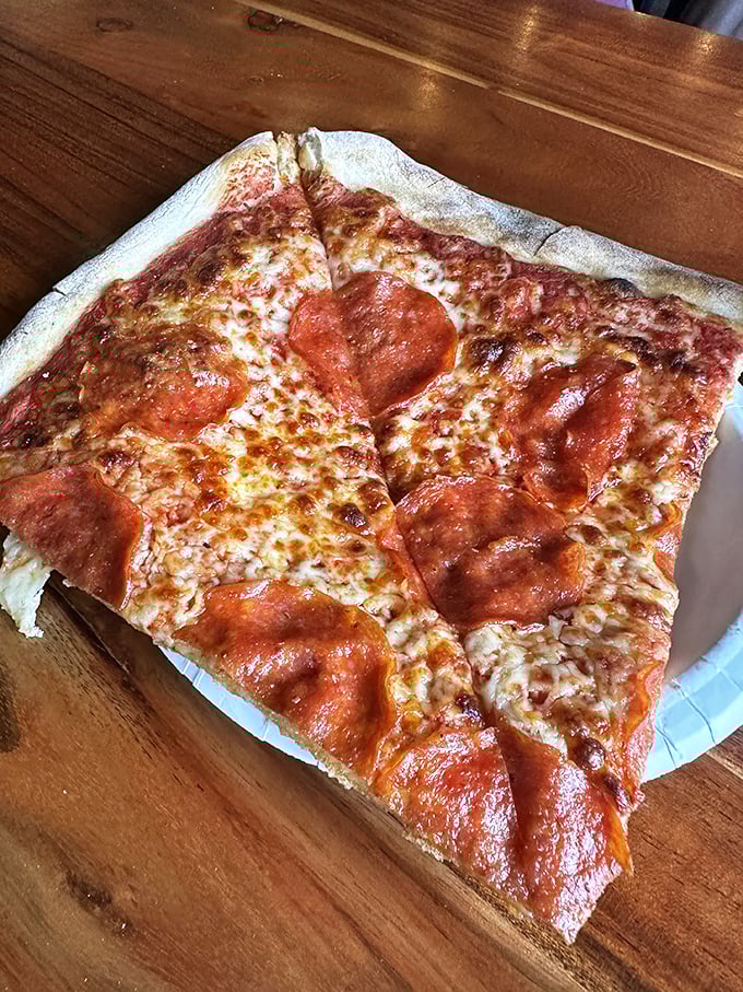 Behold, the pepperoni perfection! This slice is so loaded, it's like a meaty constellation on a crispy canvas of cheese.