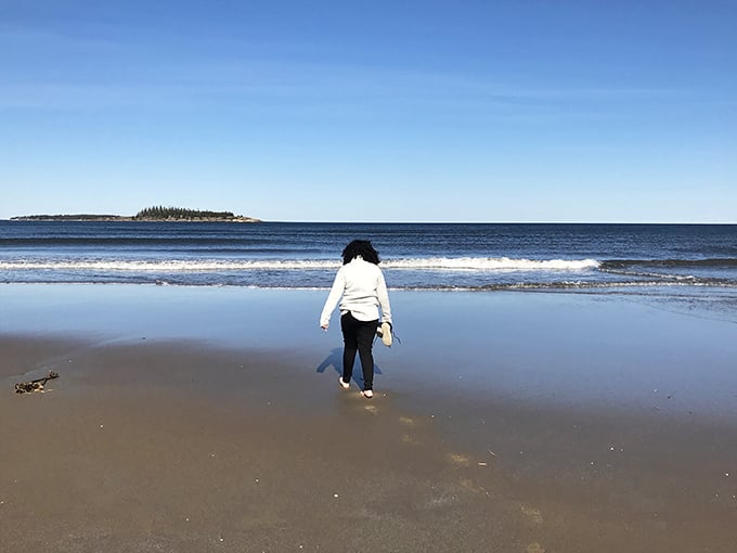 Dipping toes in the Atlantic: a time-honored tradition that never gets old. This brave soul is testing the waters, probably thinking, "I should've packed my polar bear suit!"