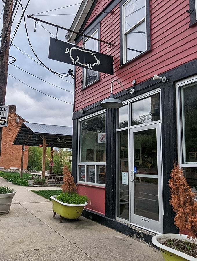 Eli's BBQ: Red exterior, black trim, and a bathtub planter? It's like your cool aunt opened a BBQ joint!