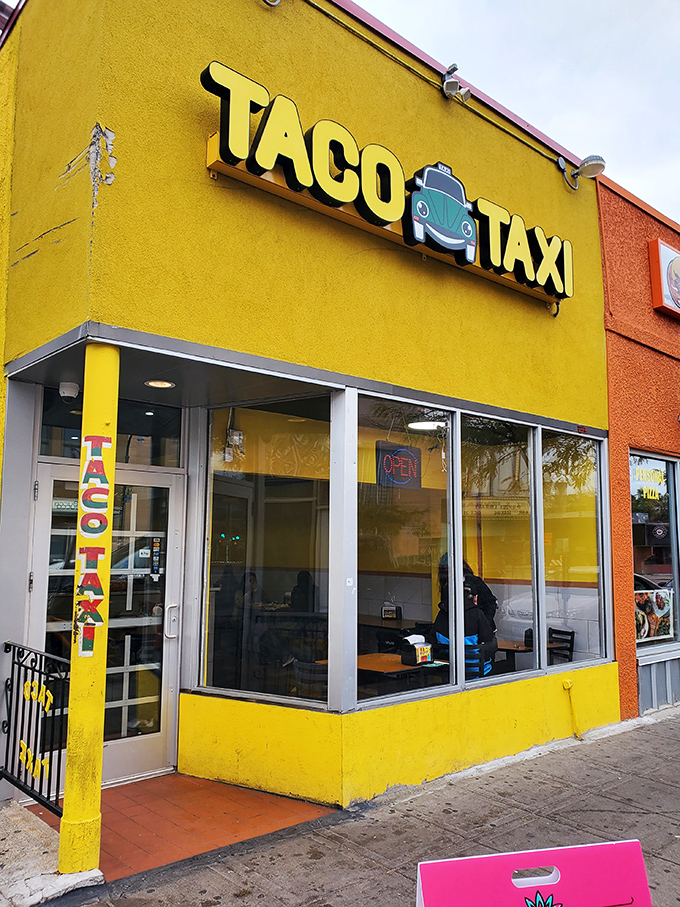 Taco Taxi: Where Mexican flavors take the wheel! This sunny spot's VW Beetle logo promises a joyride for your taste buds.