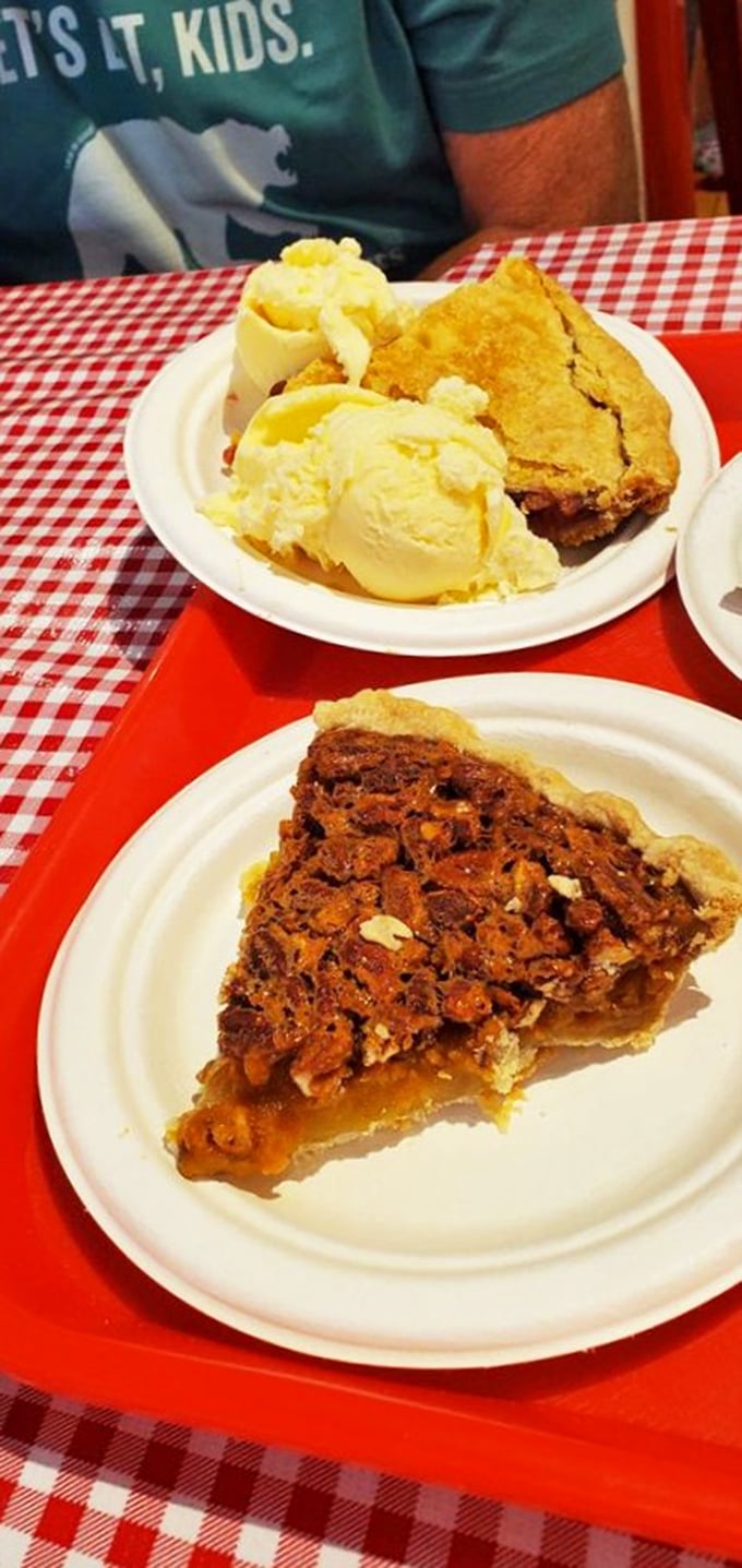 A slice of heaven, times two! Butterscotch pecan and cherry pies, crowned with ice cream. It's like a hug for your taste buds.