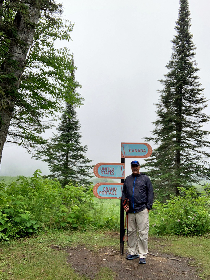 Standing at the crossroads of adventure: One small step for a hiker, one giant leap between two great nations. No passport required!