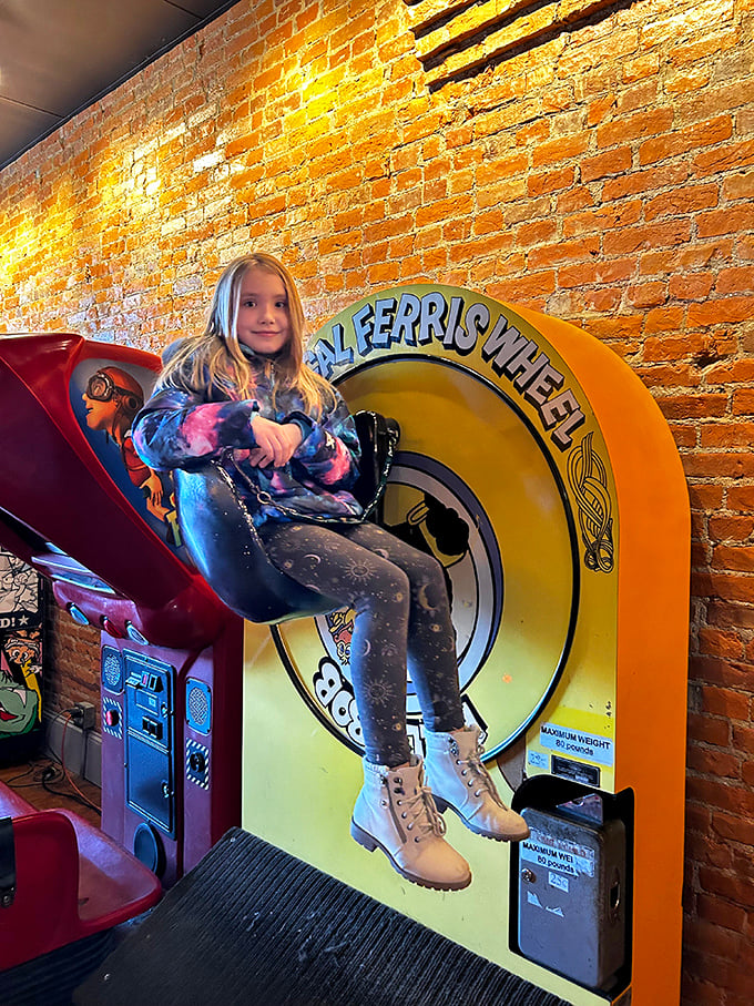 All aboard the Ferris wheel of fun! This pint-sized player proves that arcade magic transcends generations, captivating young and old alike.