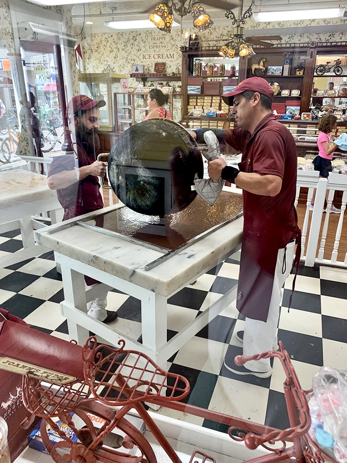 Fudge wizardry in action! Watch as skilled confectioners transform liquid sugar into slabs of joy. It's like edible alchemy, folks.