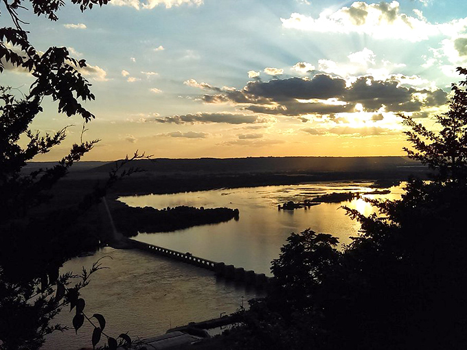 Alma's sunset game is stronger than your grandma's coffee. The Mississippi reflects the sky's colors like nature's own mood ring, constantly changing and always stunning.