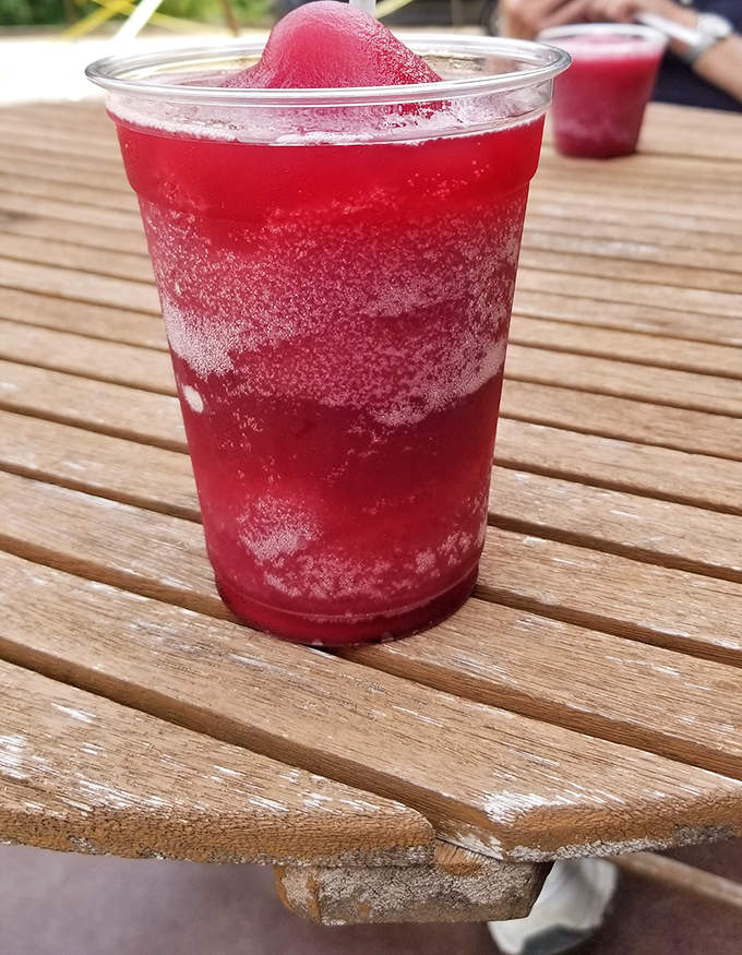 Sipping in style! This vibrant slushy isn't just a drink, it's an outdoor adventure for your taste buds. Talk about a grape escape!