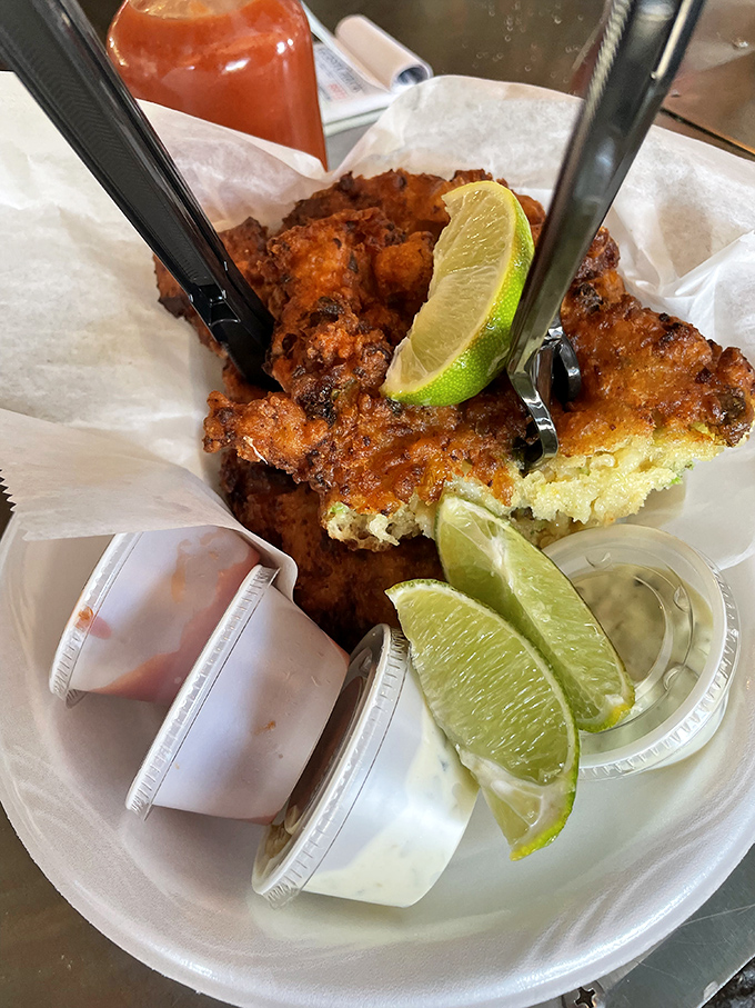 Conch fritters: the unsung heroes of seafood. Paired with zesty dipping sauce, they're like a flavor explosion in your mouth.