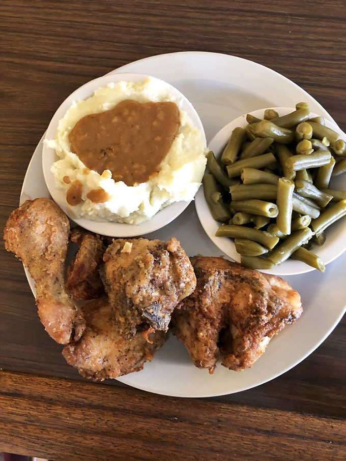 A plate that screams "comfort food"! Crispy chicken, creamy mashed potatoes, and green beans – it's like a hug for your taste buds.